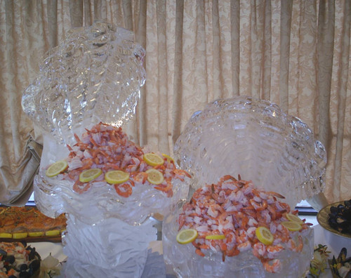 Two Clam Shells on Waves for Seafood Display. | ice and fruits