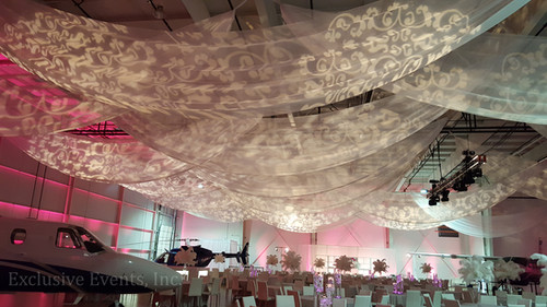 Swooping Drape with Floral Lighting | Exclusive Events Inc