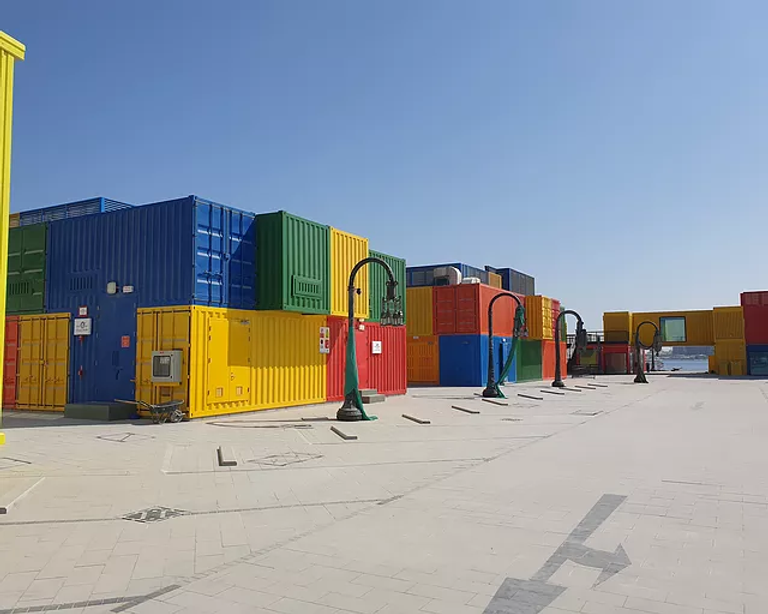 An eclectic street with shops housed in colourful containers