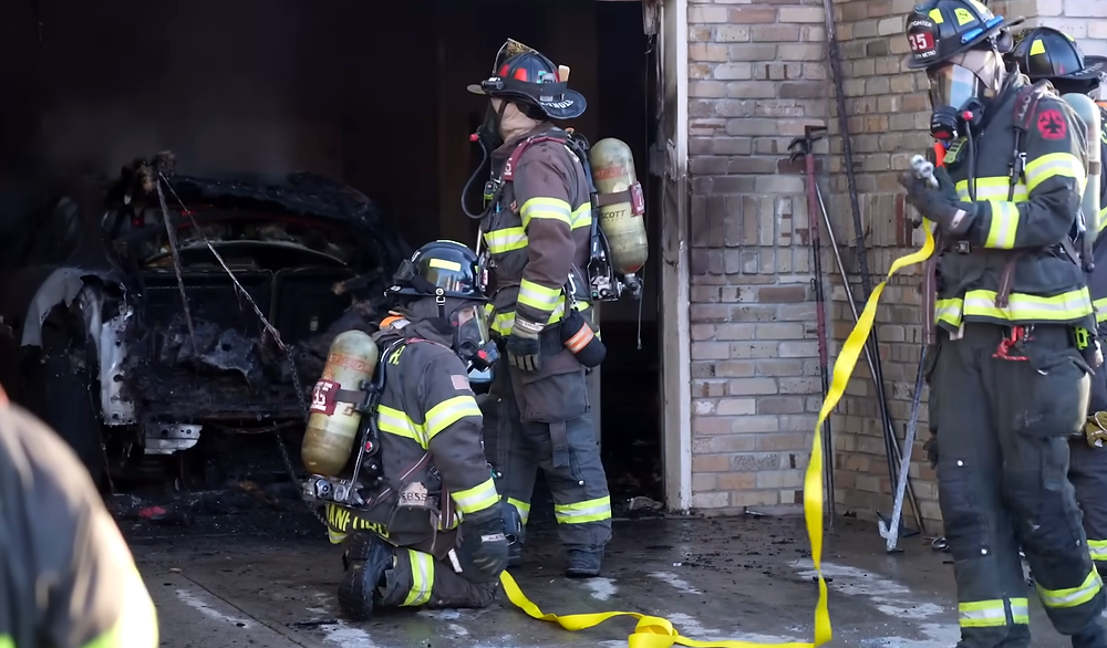 Fire Department responding to a burning EV inside a home garage