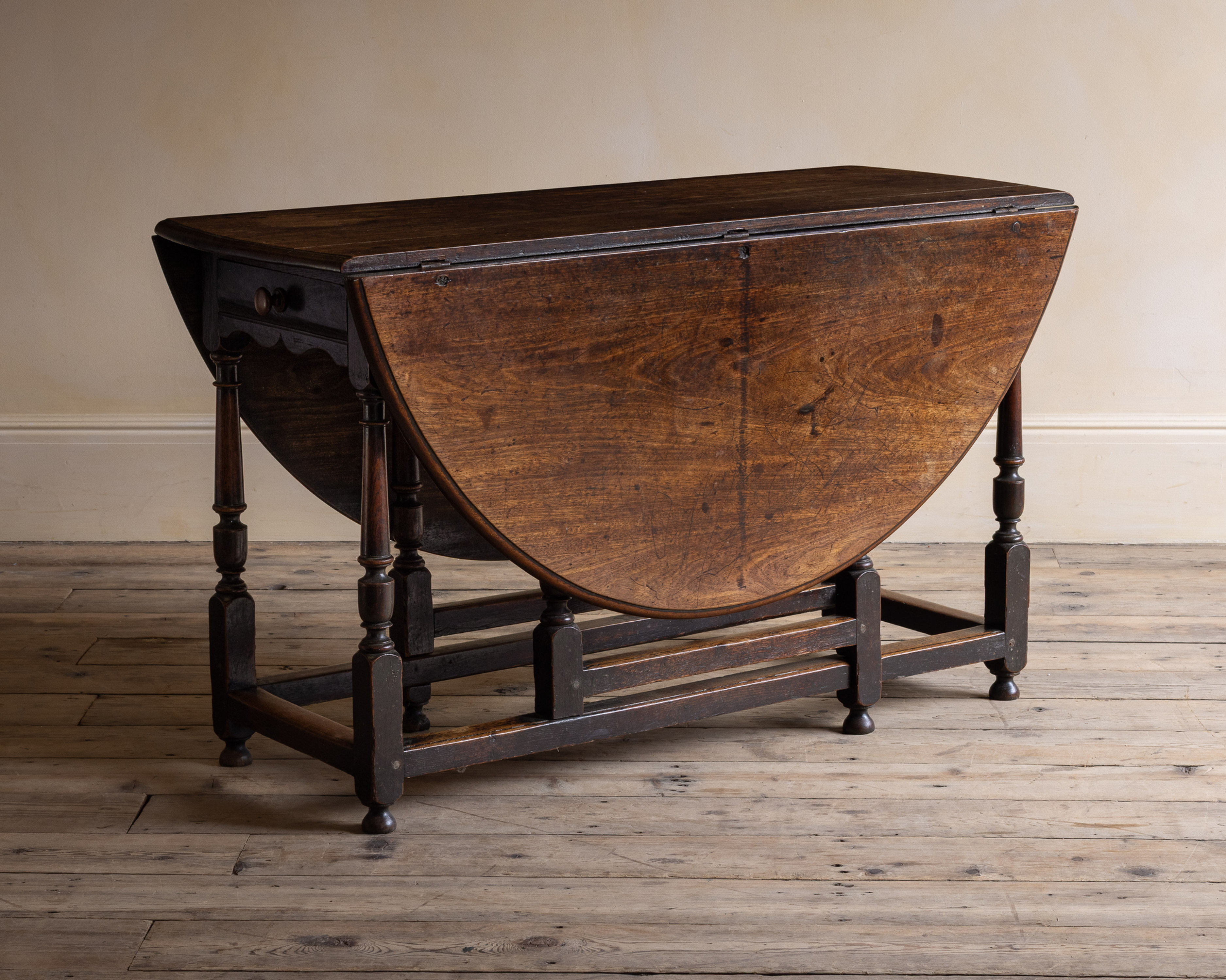An oak and mahogany gate-leg table