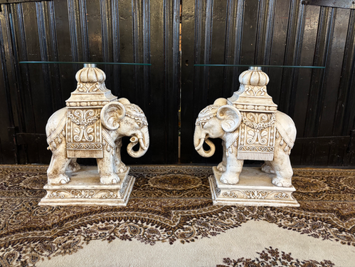 Pair of ornate elephant side tables with a circular glass top ...