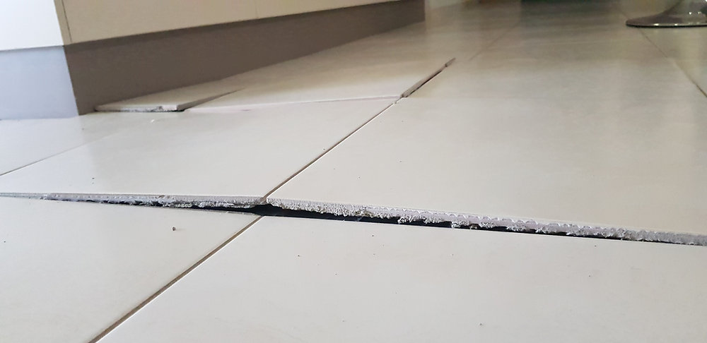 Why do tiles lift and 'pop up'?