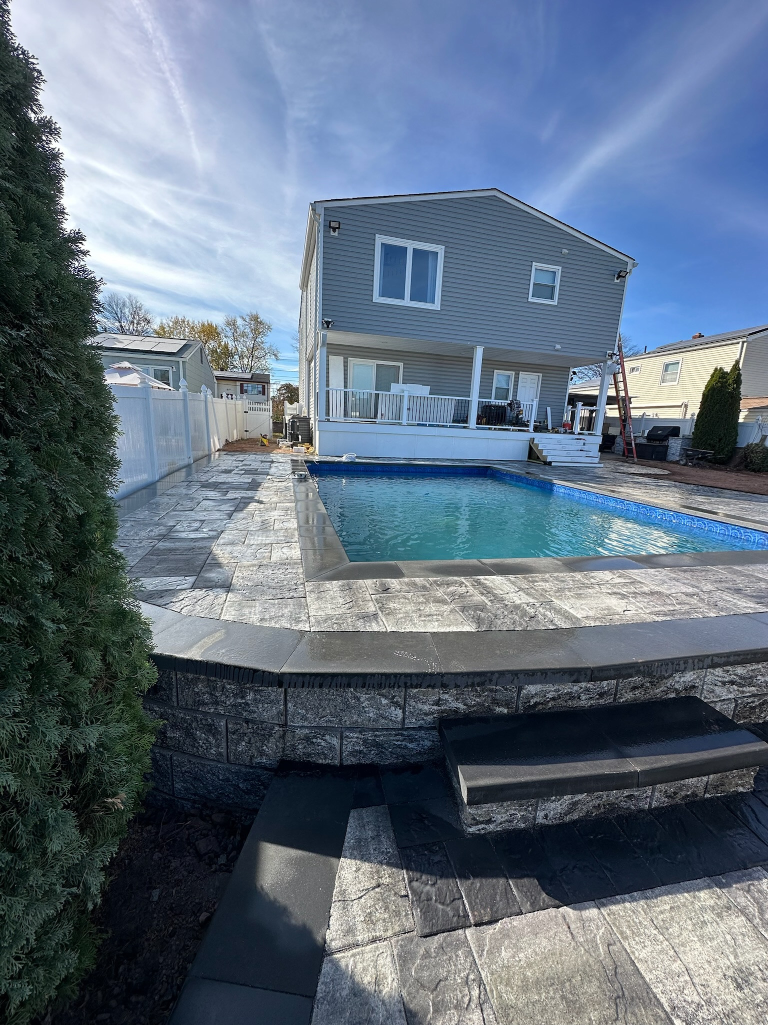 Modern Semi Inground Pool with Dark Paver Patio and Tiered Steps | Zee ...