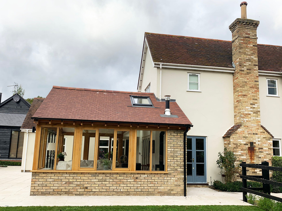 Garden room extension with oak frame and glazing between studs