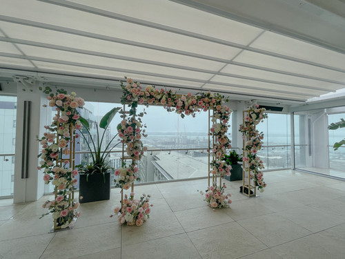 gold truss frame with floral arrangement | The Journey Wedding