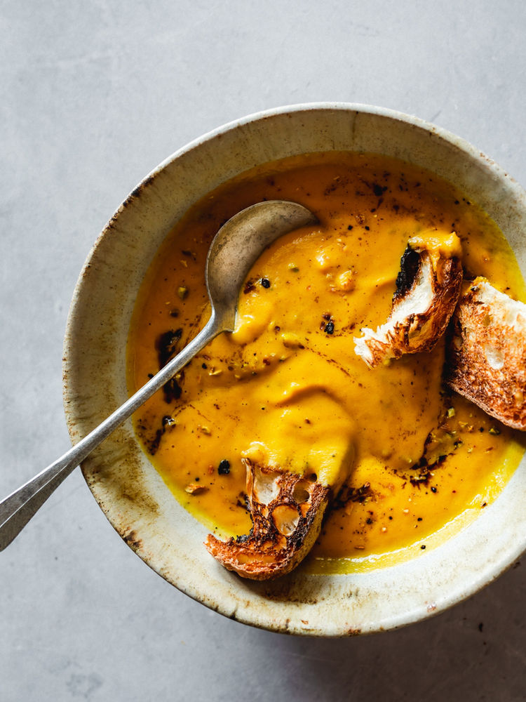 Pumpkin miso soup with pumpkin oil and toasted pistachios