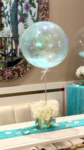 Balloon Centerpiece with Glitter and Feathers Inside in a Small Flower ...