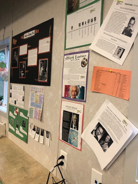 The classroom walls are filled with end of term projects and assignments