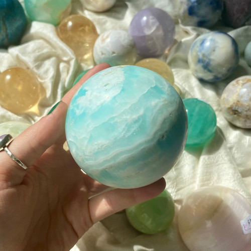 Large caribbean calcite sphere | Wildflower Gems | Online Crystal Shop