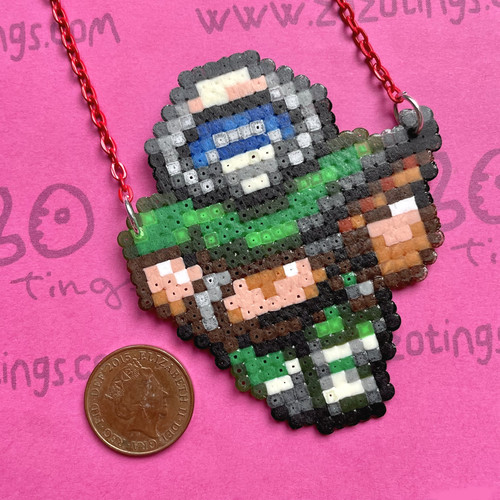 Buy our DOOM 'Doomguy' Pixel Necklace brought to you by ZoZoTings.com