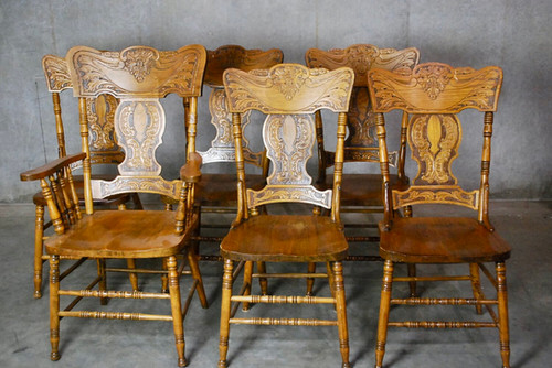 A set of six early 20thC Canadian oak press-back chairs, with heavy ...