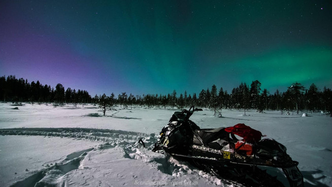 Night snowmobile safari in search of the Northern Lights in Levi