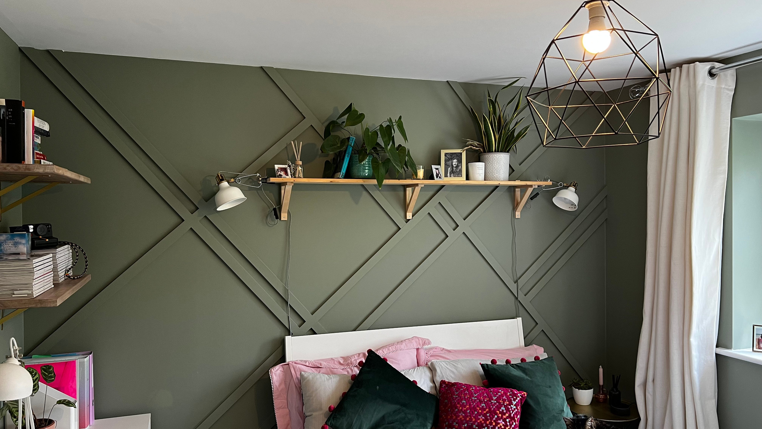 A bedroom painted earthy olive green