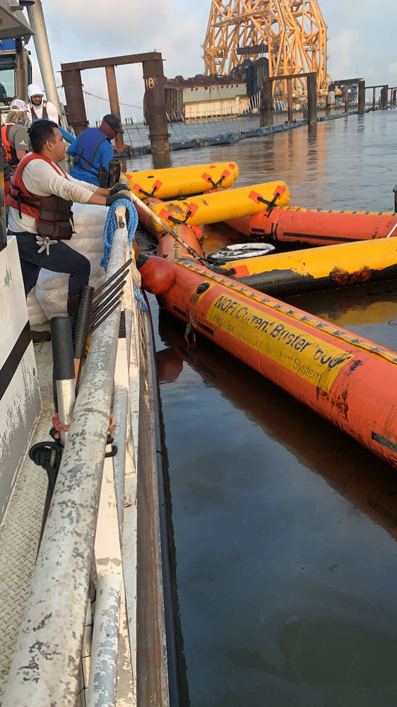 Shoreline clean-up teams recover oil